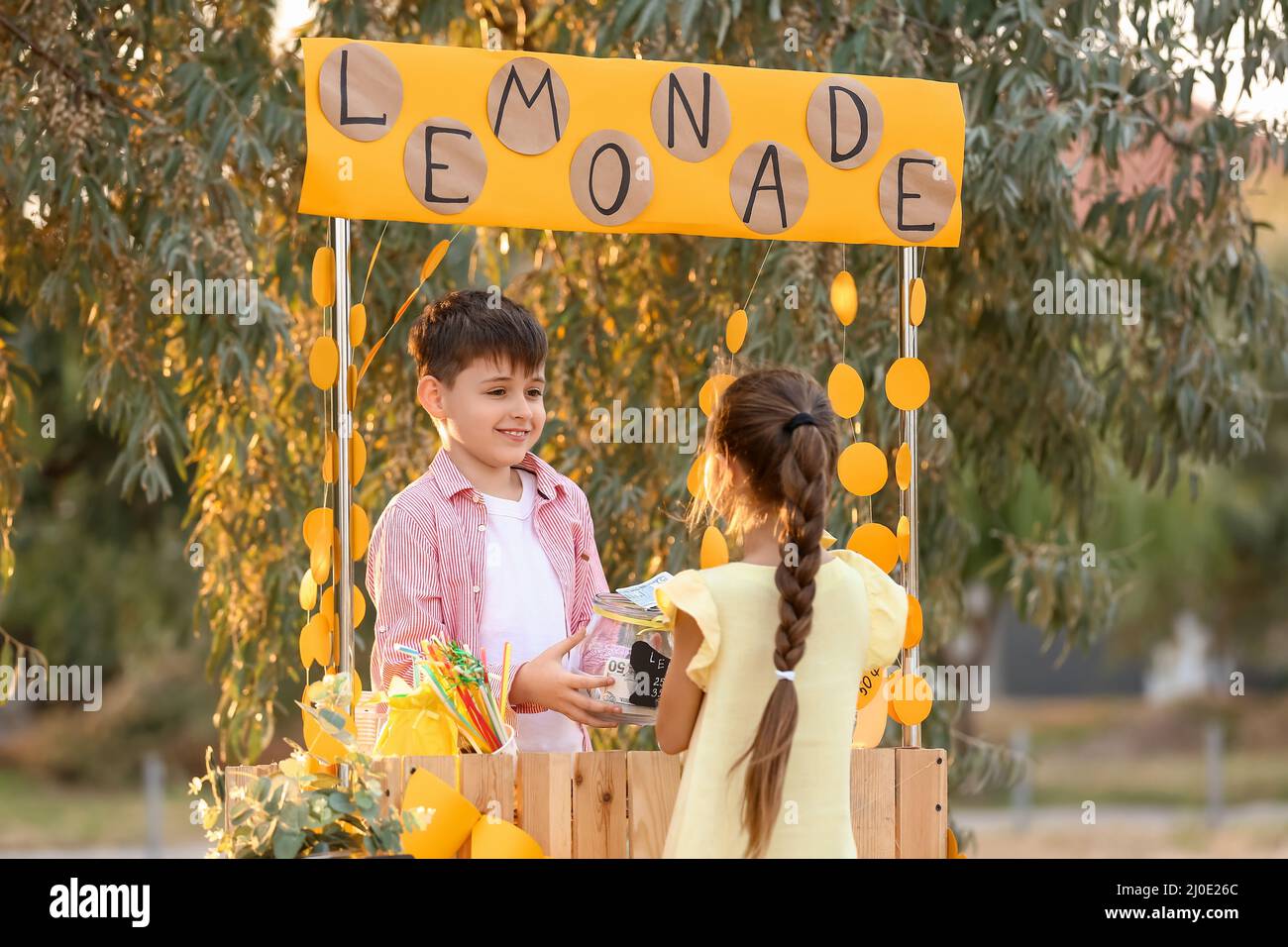 Cute boy selling lemonade in park Stock Photo - Alamy