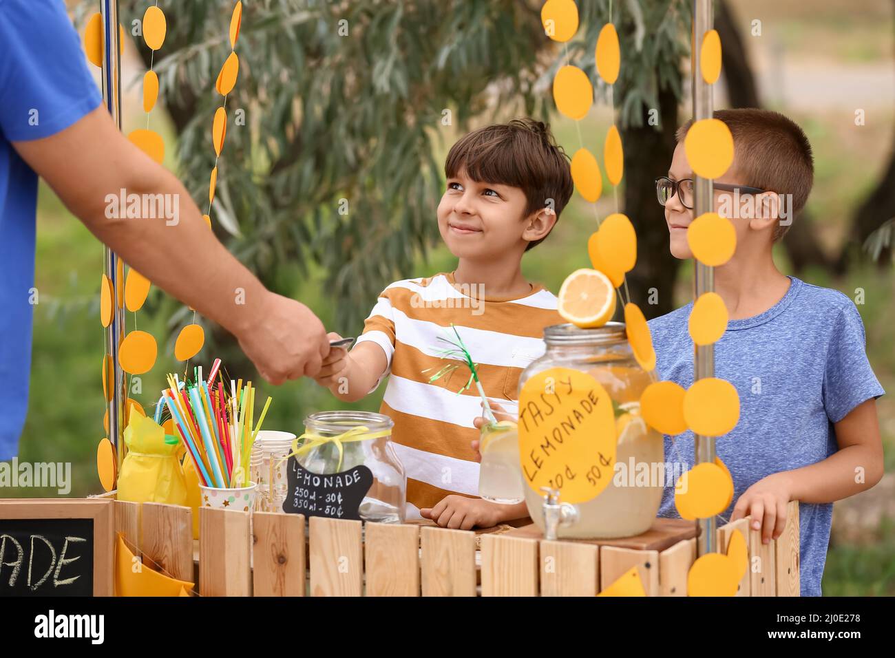 Cute children selling lemonade in park Stock Photo - Alamy