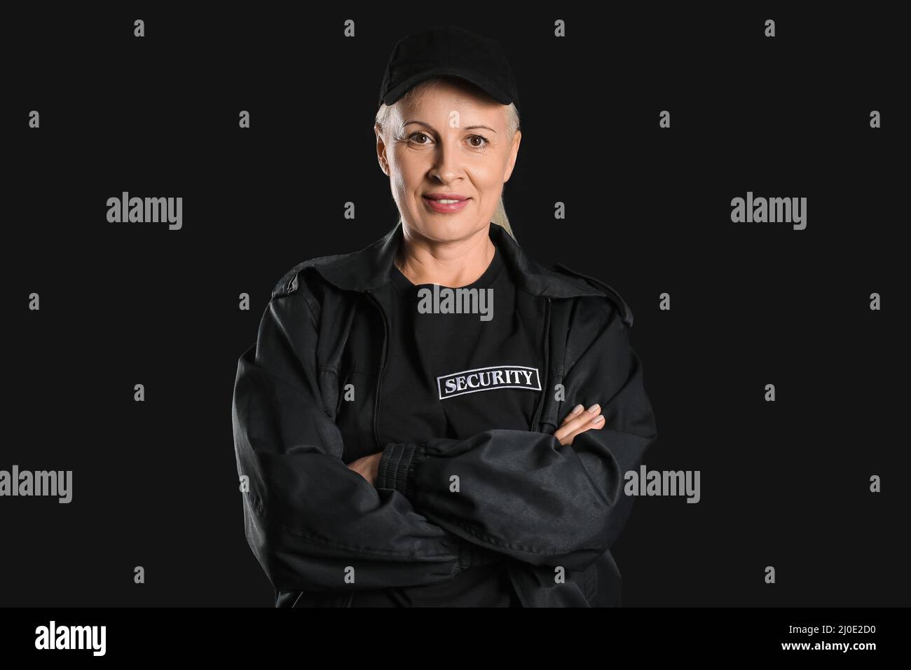 Female security guard on dark background Stock Photo - Alamy