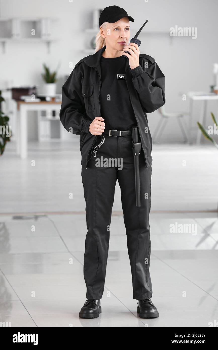 Female security guard with radio transmitter in office Stock Photo - Alamy
