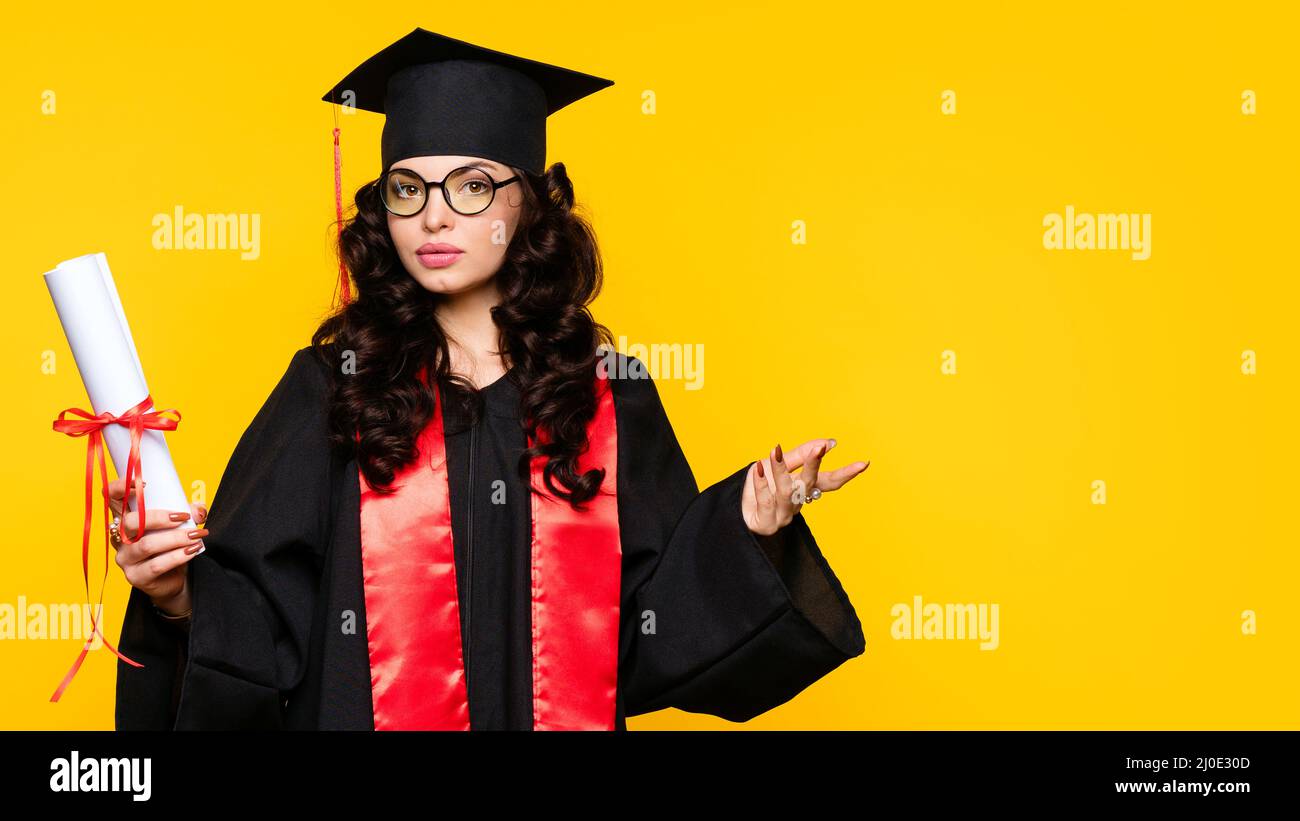 Girl graduate in graduation hat and eyewear with diploma on yellow ...