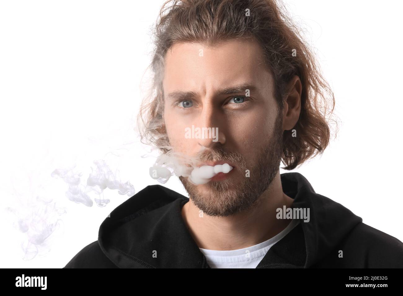 Smoking young man isolated on white Stock Photo - Alamy