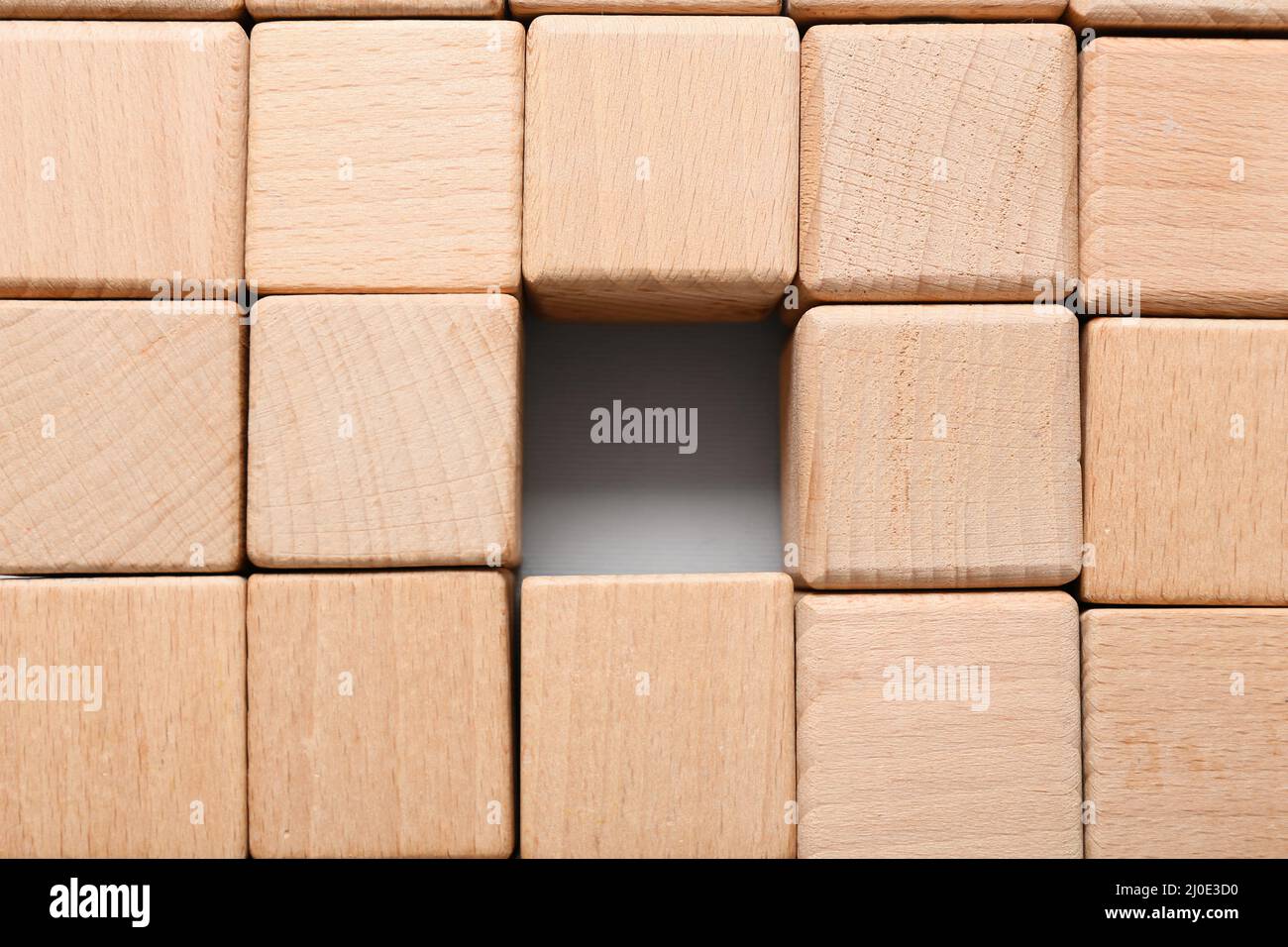 Texture made of many wooden cubes with one missing block in center ...