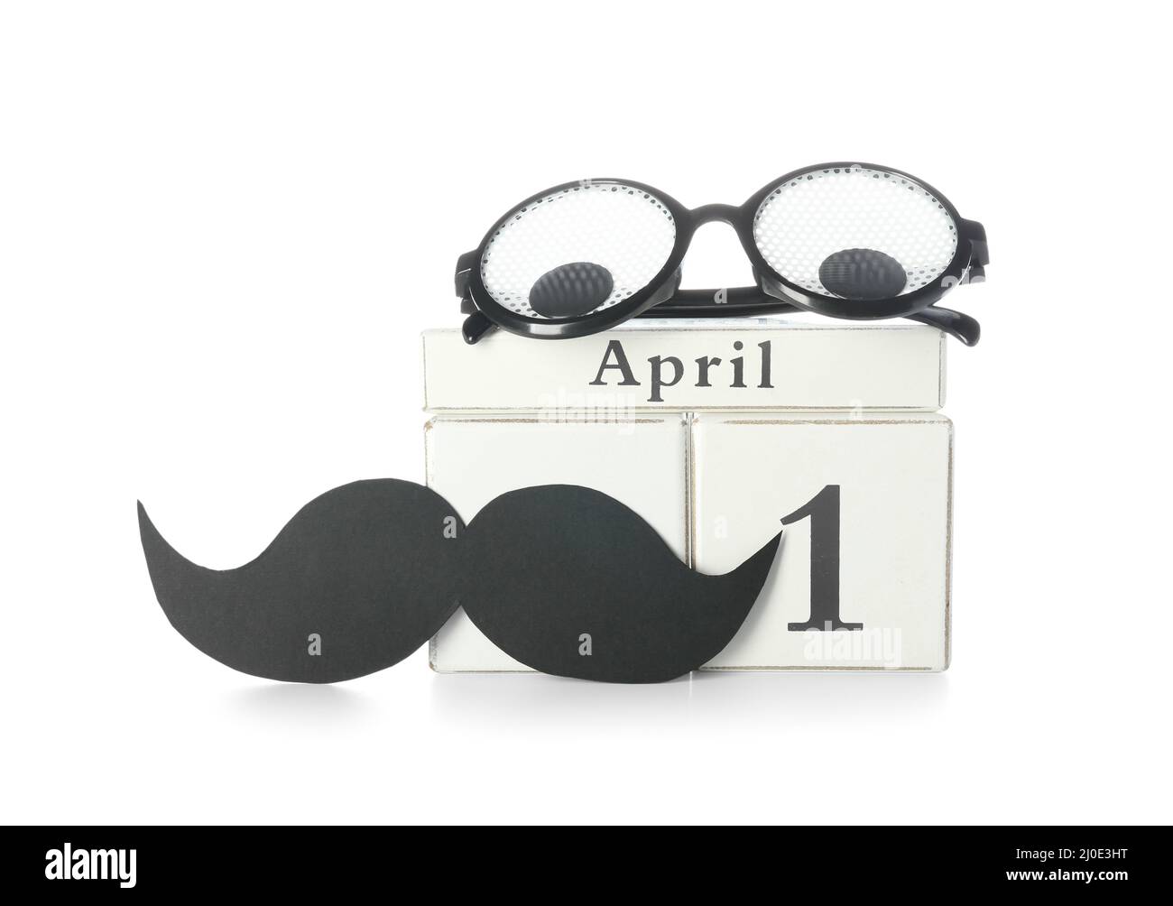 Party decor for April Fools Day celebration and cube calendar on white ...