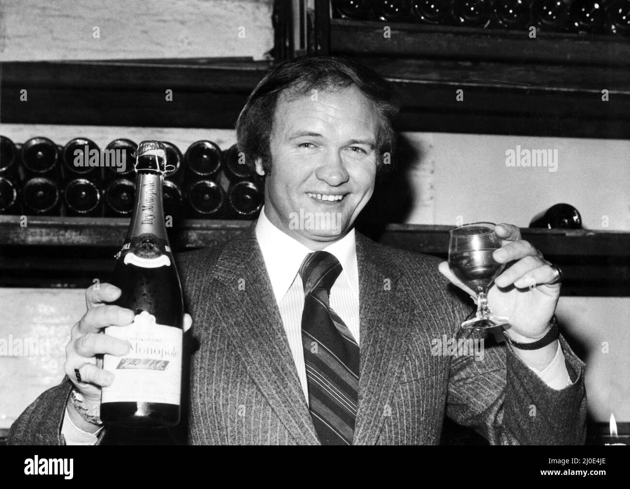 West Bromwich Albion football manager Ron Atkinson holds up a bottle of ...