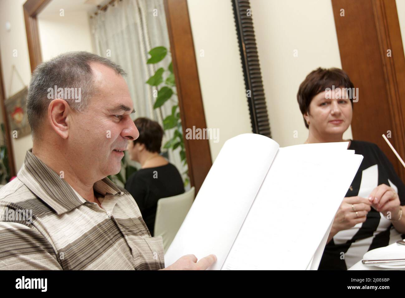 The man reading a menu in a restaurant Stock Photo - Alamy