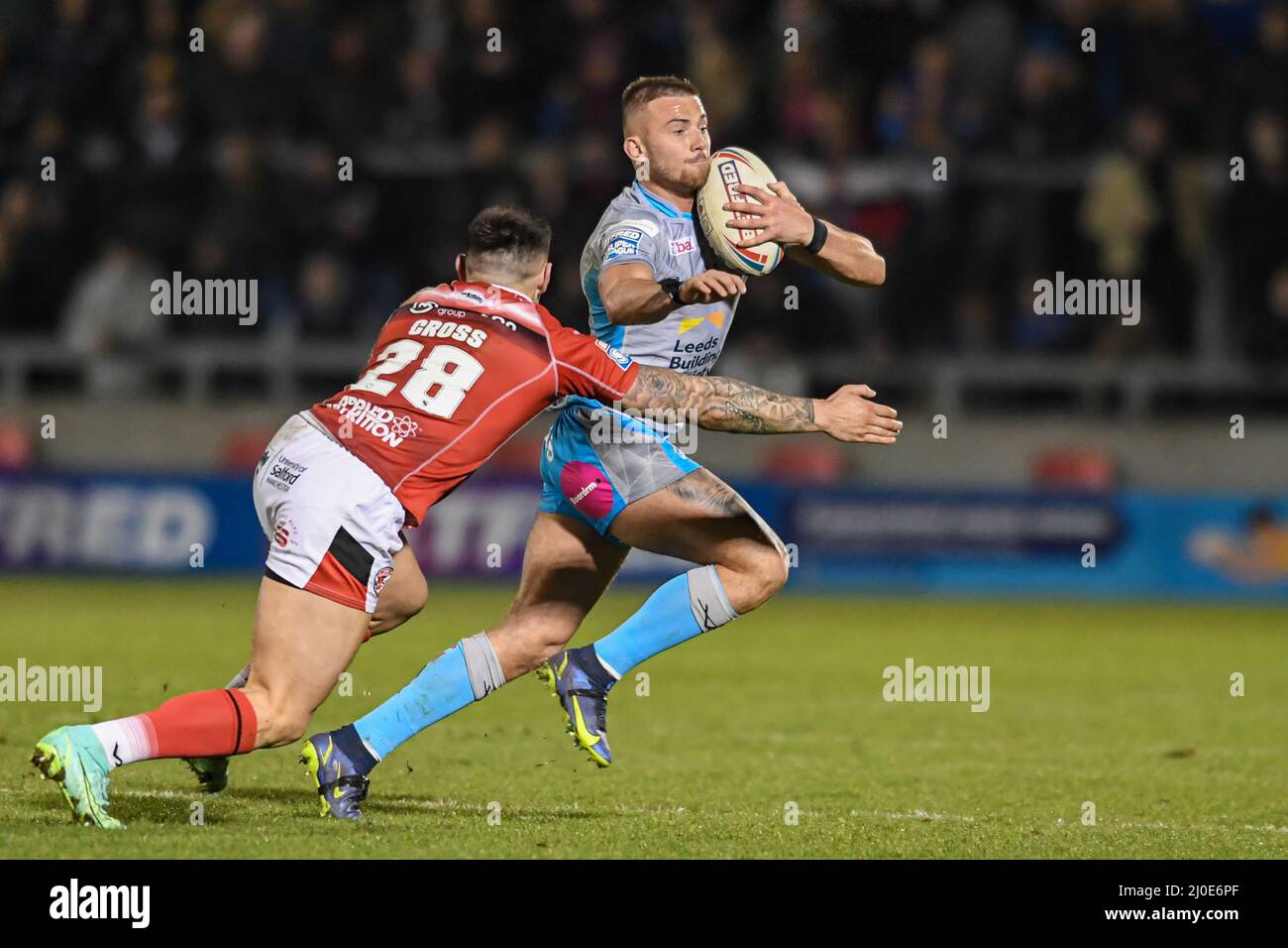 Jack Walker #1 of Leeds Rhinos is tackled by Deon Cross #28 of Salford ...