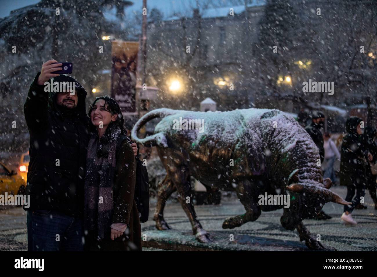 Istanbul, Turkey. 18th Mar, 2022. A bull statue is covered with snow ...