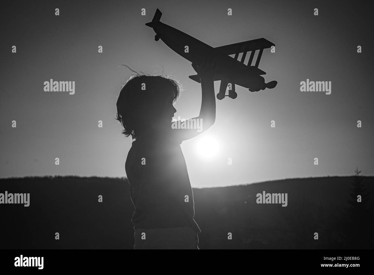 Child pilot aviator with airplane dreams of traveling on sunset Stock ...