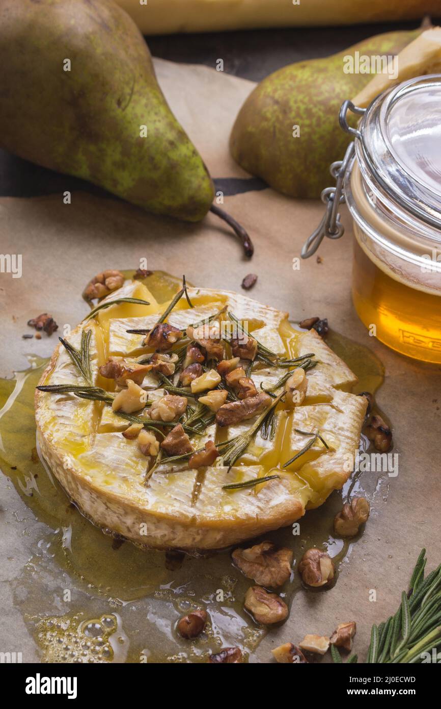 Delicious baked camembert with honey, walnuts, herbs and pears Stock ...