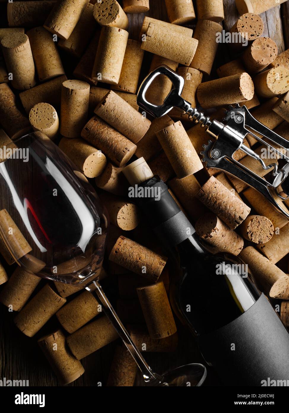 Luxurious composition - a bottle of red wine, corks and a corkscrew ...