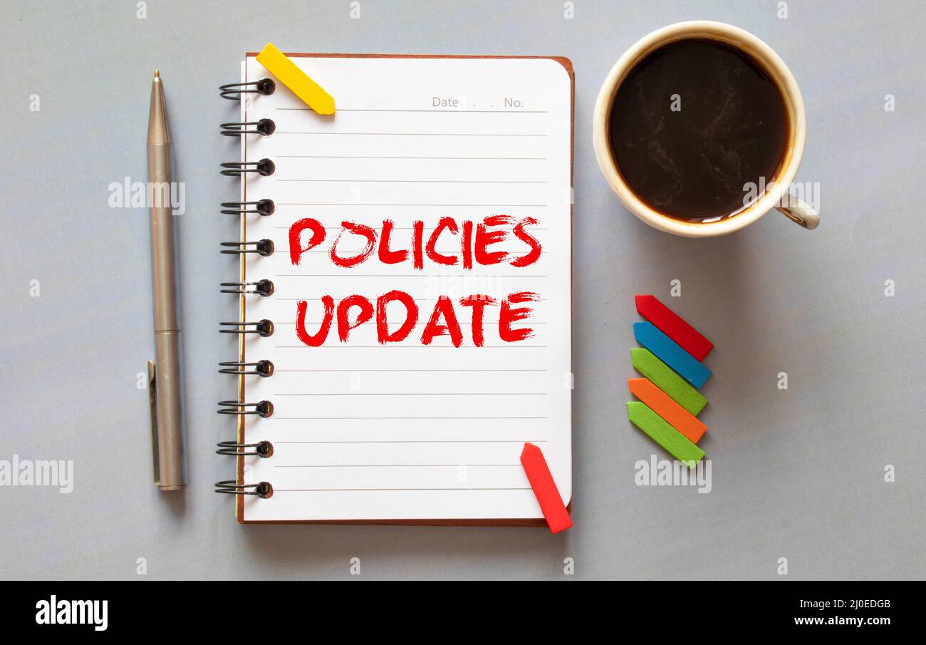 Policies update memo written on a notebook with pen, calculator and ...