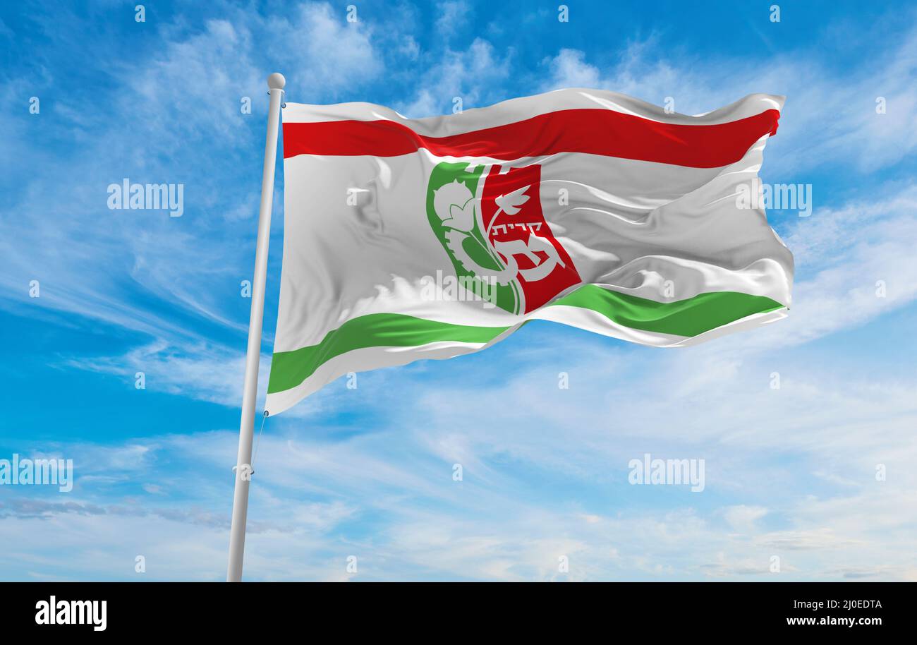 flag of Qiryat Gat , Israel at cloudy sky background on sunset ...
