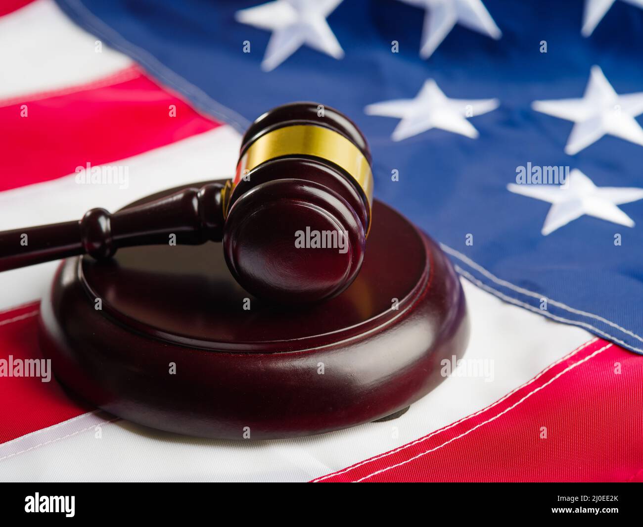 Macro shot. Judge's gavel on the background of the national flag of the ...