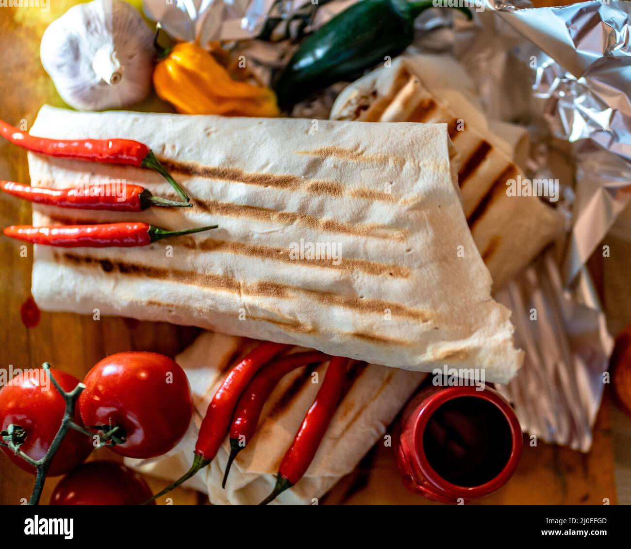 Top view of fresh just made shawarma and ripe vegetables on the table ...