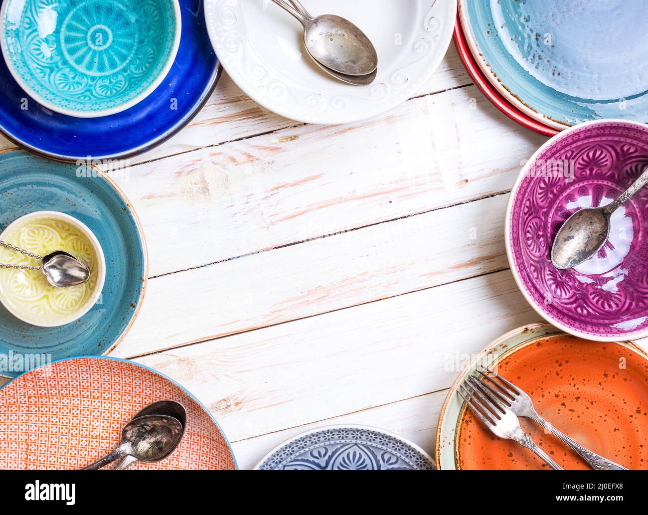 Different empty plates background Stock Photo - Alamy