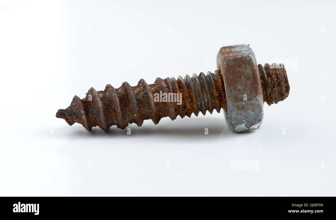 Rusty nut and bolt. A rusty screw lying against a white background ...