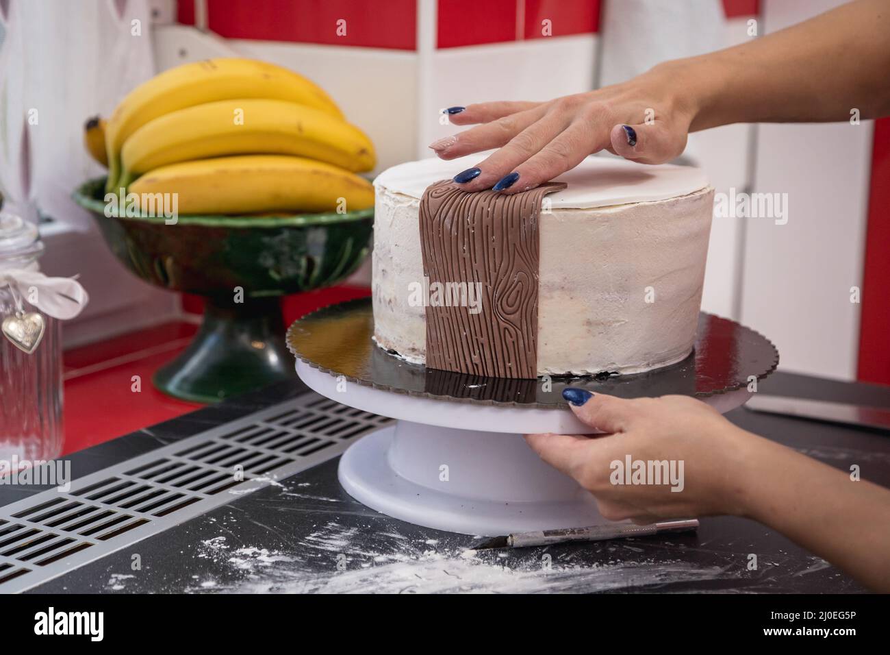 Person decorating a cake with marzipan Stock Photo - Alamy