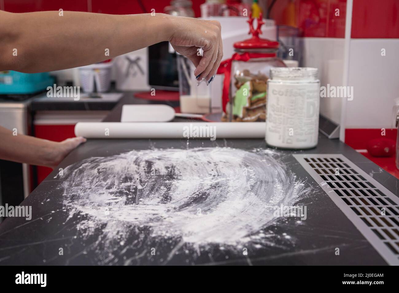 Person pouring flour on a table for baking Stock Photo - Alamy