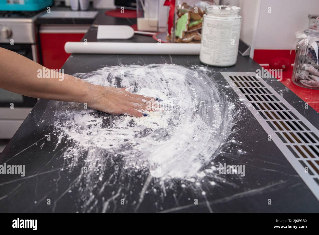 Person pouring flour on a table for baking Stock Photo - Alamy