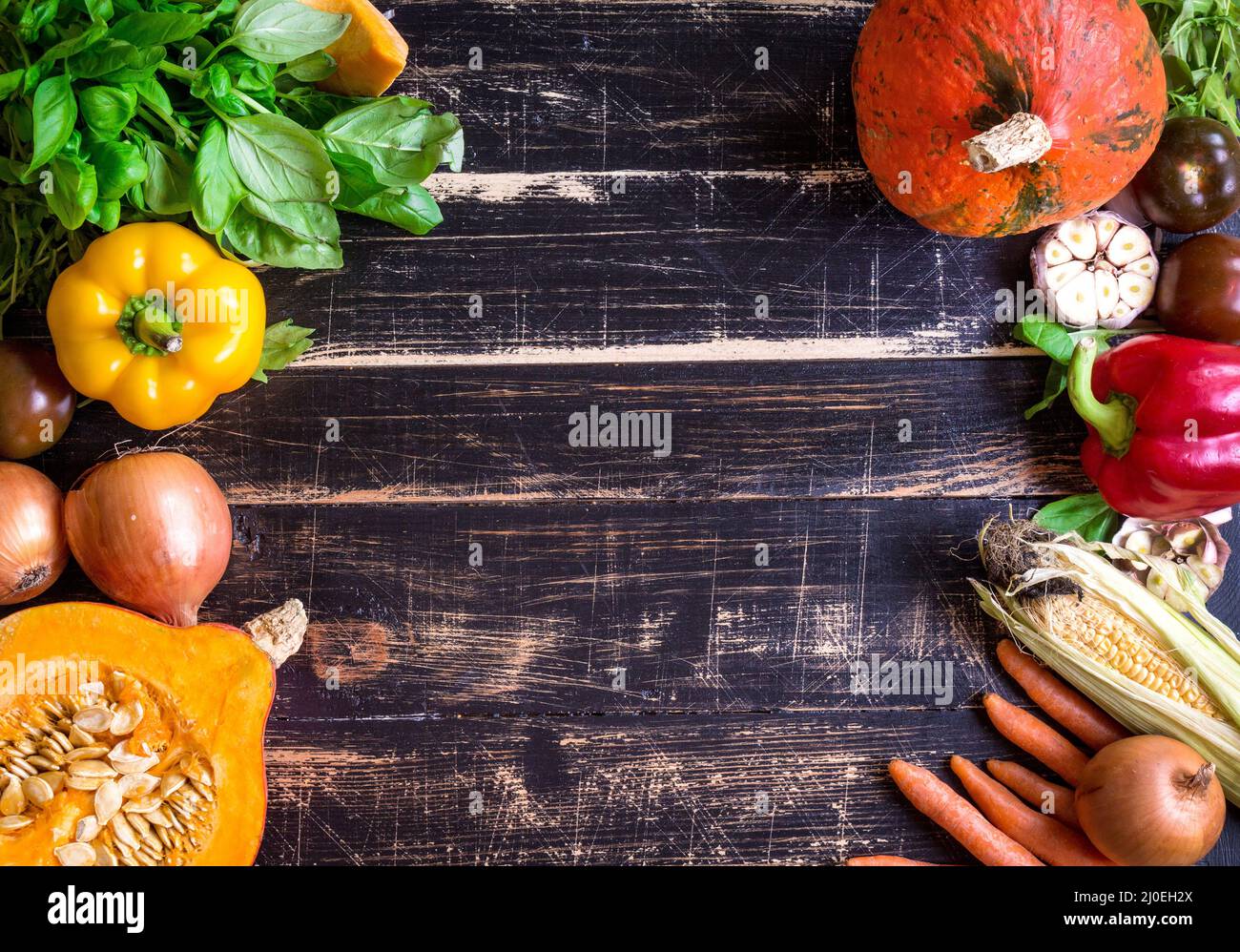 Fresh vegetables on a rustic dark textured table. Autumn background ...