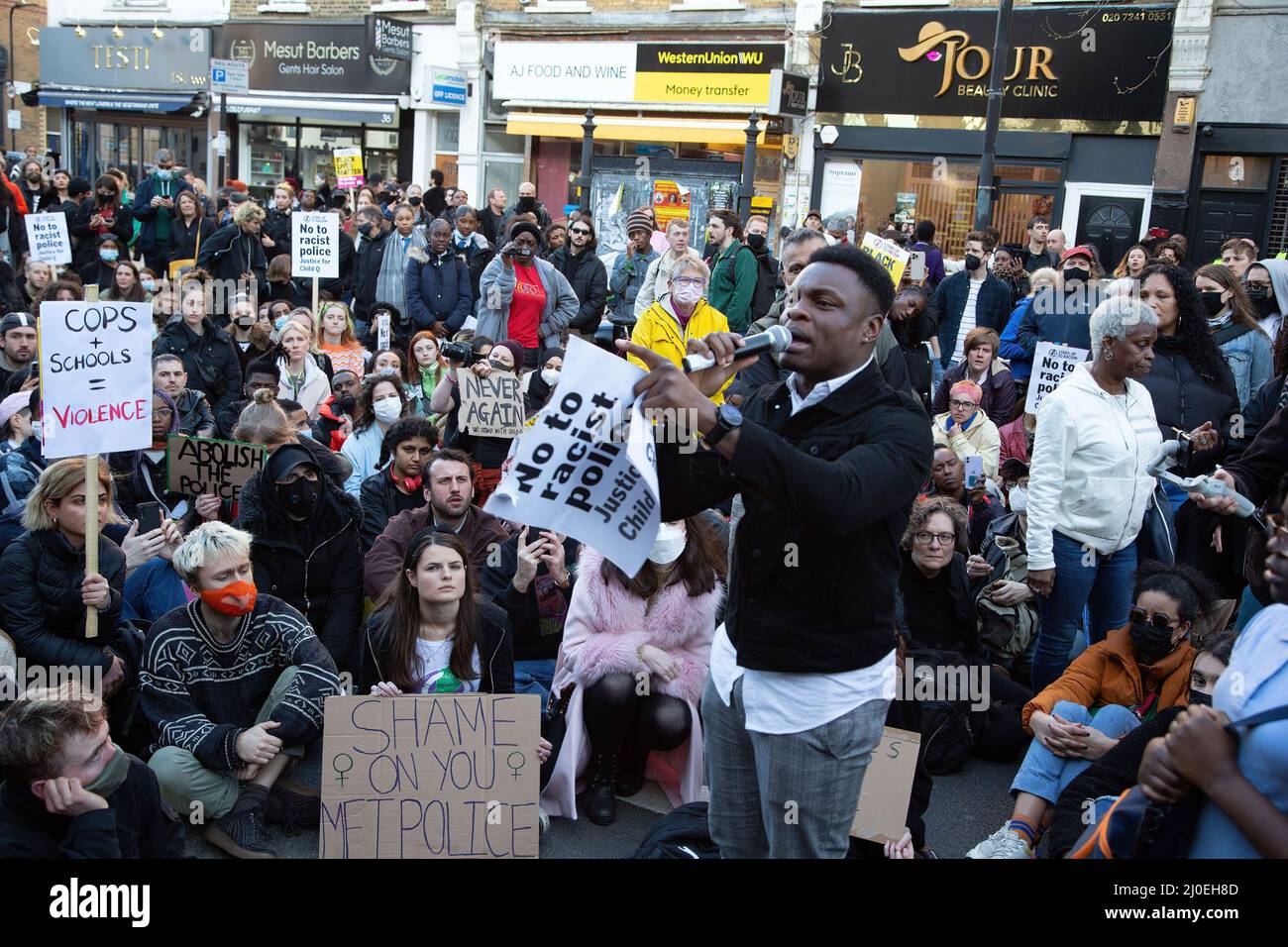 London, UK. 18th Mar, 2022. Protesters hold placards expressing their ...