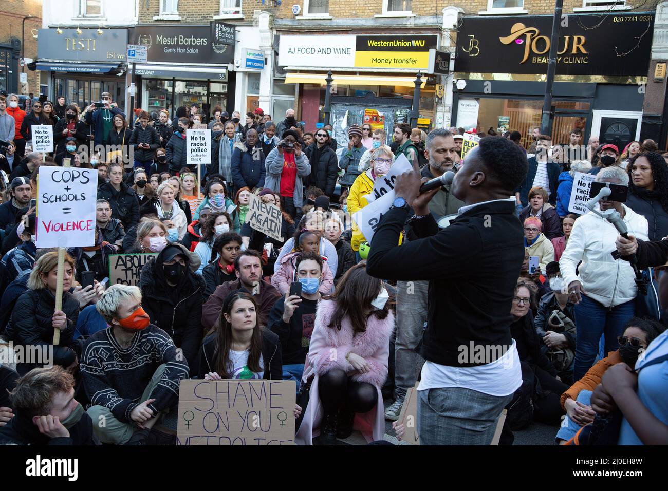 London, UK. 18th Mar, 2022. Protesters hold placards expressing their ...