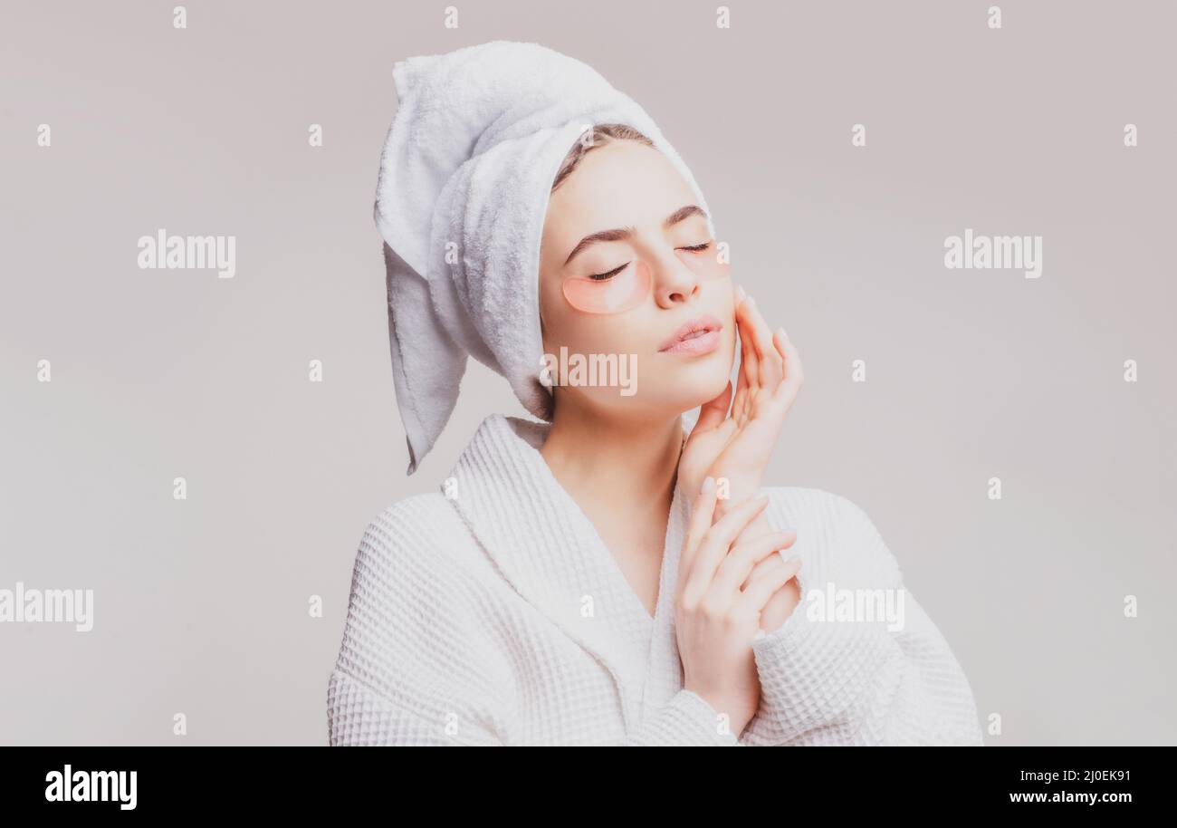 Woman applying eye patches. Calm relaxed woman has fresh healthy skin ...