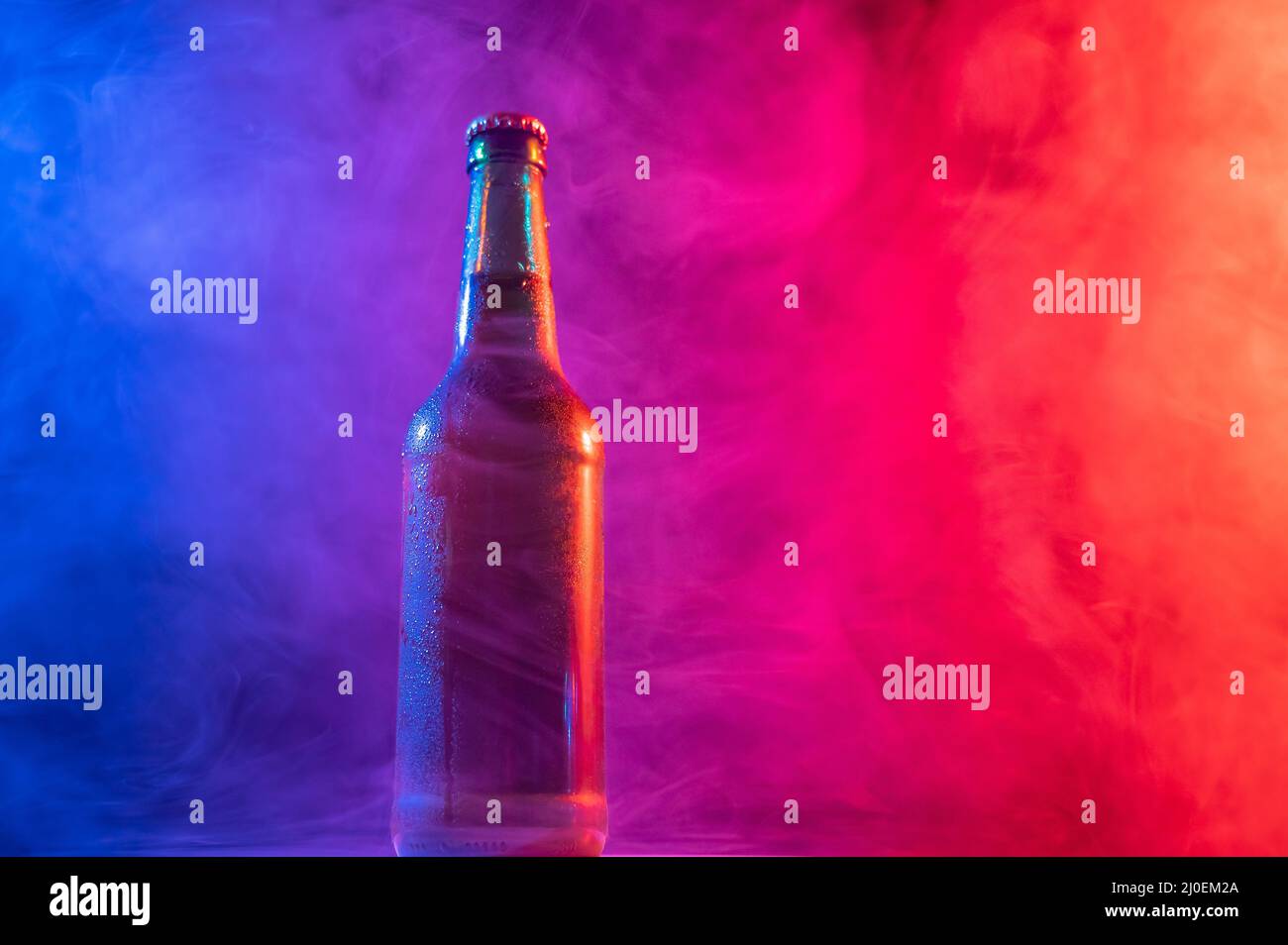Glass bottle of beer in blue pink mist Stock Photo - Alamy