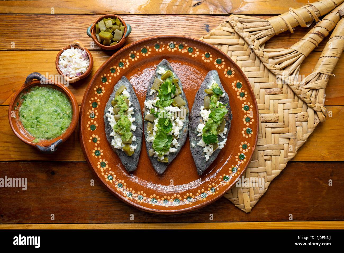 Traditional mexican tlacoyos with green sauce and nopal cactus Stock ...