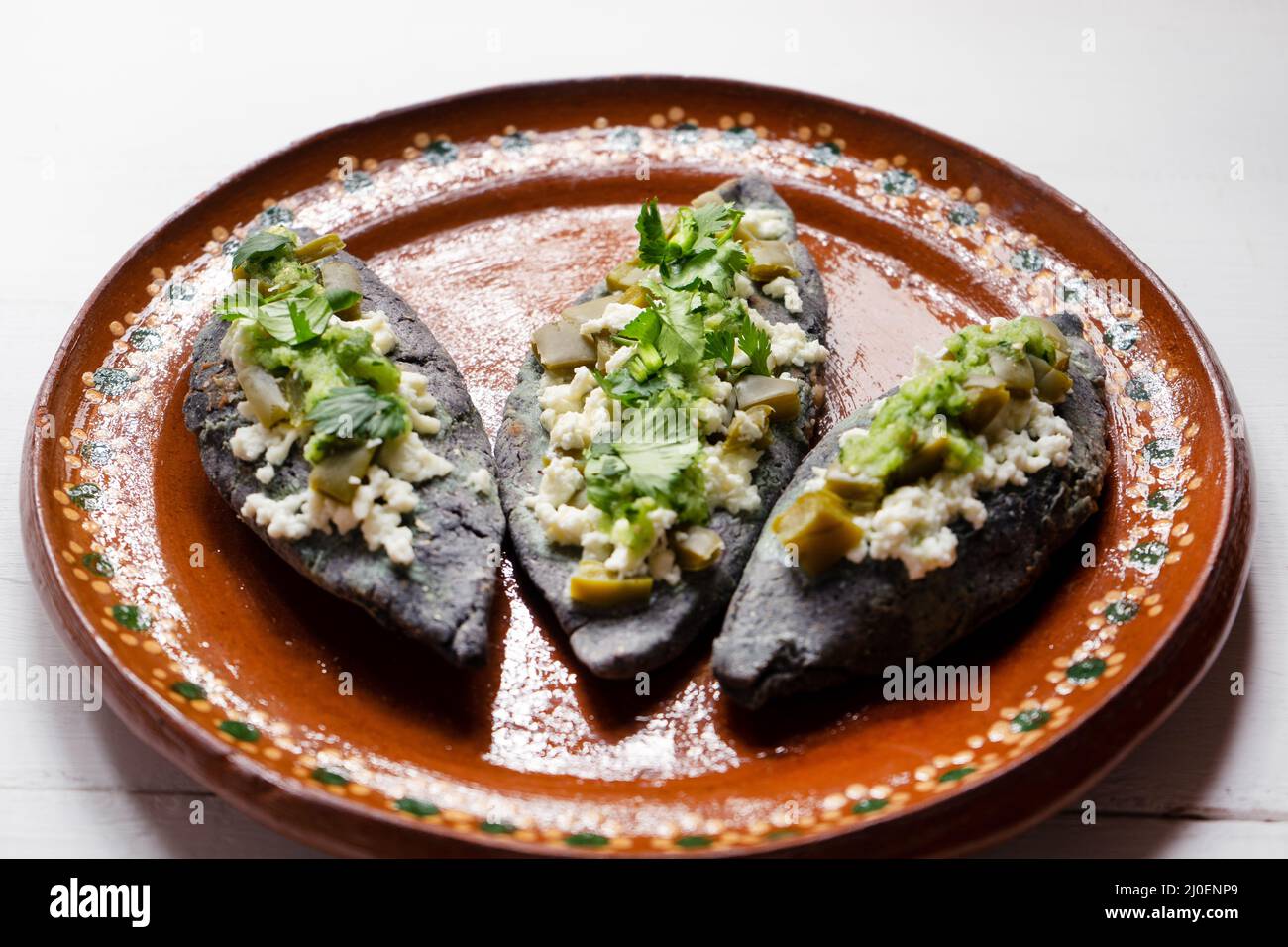 Traditional mexican tlacoyos with green sauce and nopal cactus Stock ...