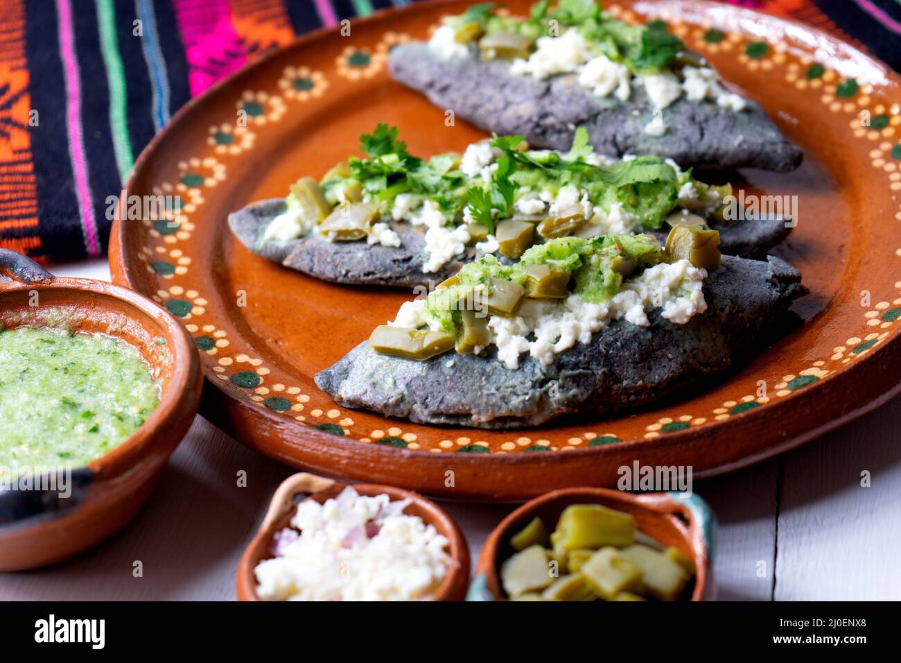 Traditional mexican tlacoyos with green sauce and nopal cactus Stock ...