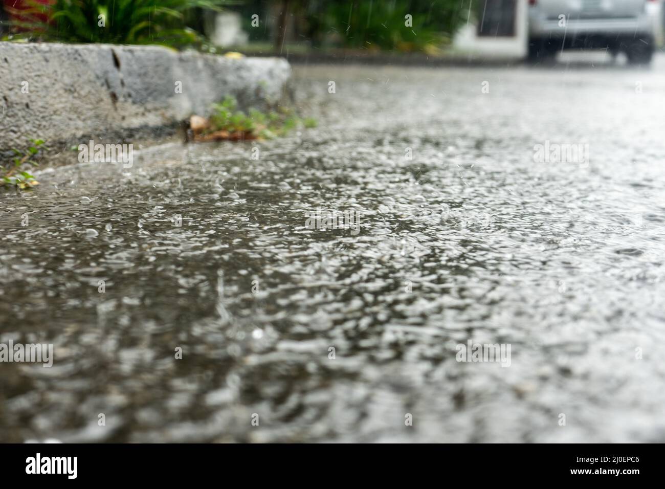 Raindrop falling on street hi-res stock photography and images - Alamy