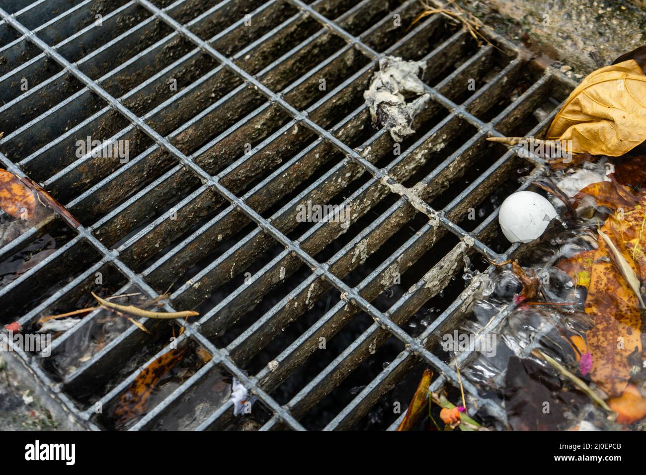 Street drainage and garbage Stock Photo - Alamy