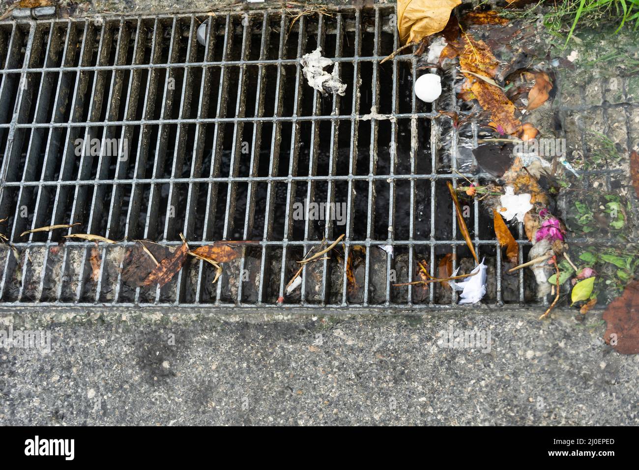 Street drainage and garbage Stock Photo - Alamy