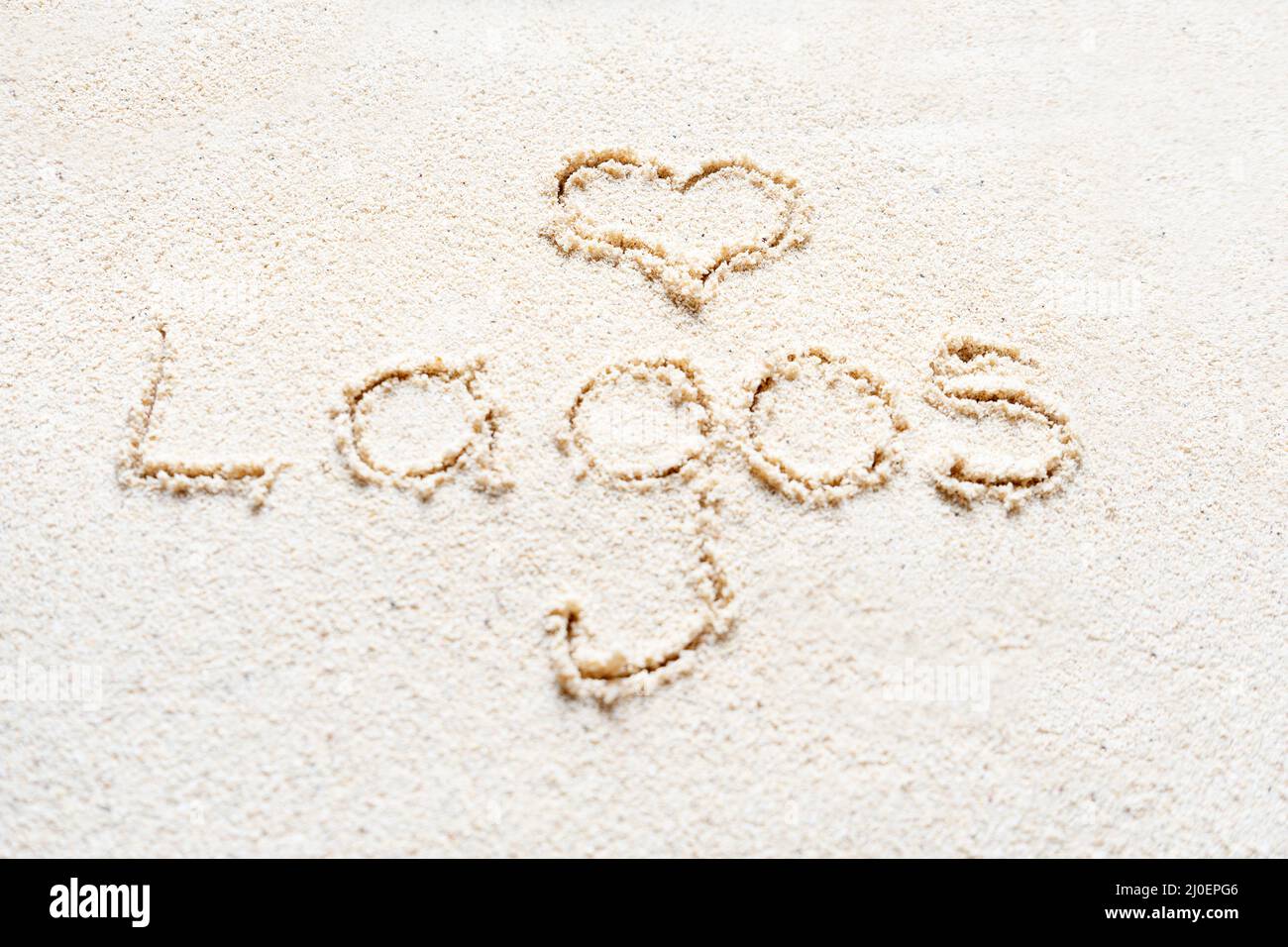 Handwriting words "Lagos" on sand of beach Stock Photo - Alamy