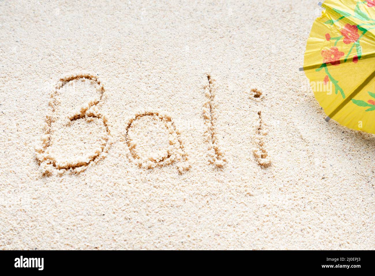 Handwriting words "Bali" on sand of beach Stock Photo - Alamy