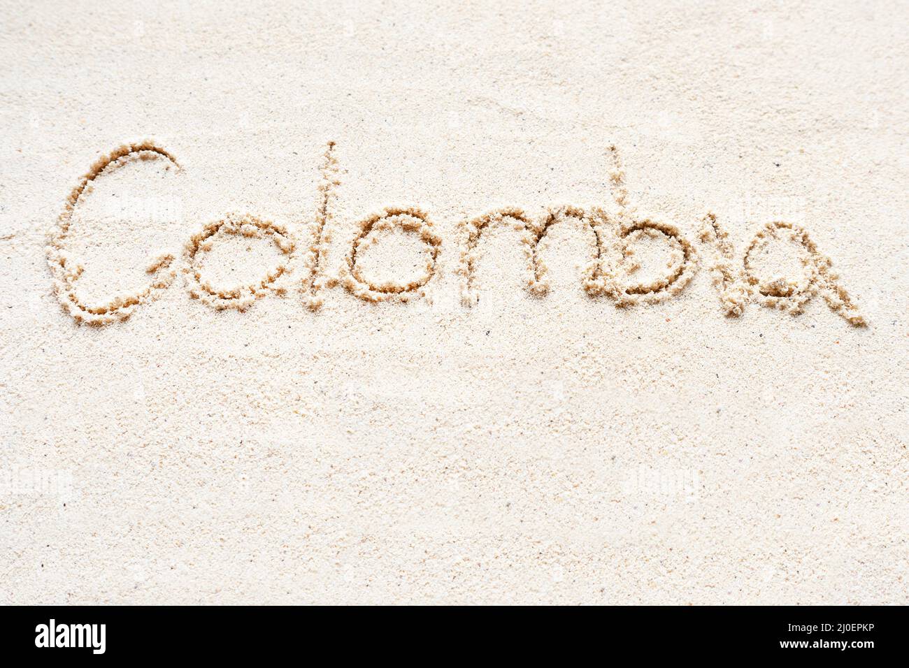 Handwriting words "Colombia" on sand of beach Stock Photo - Alamy