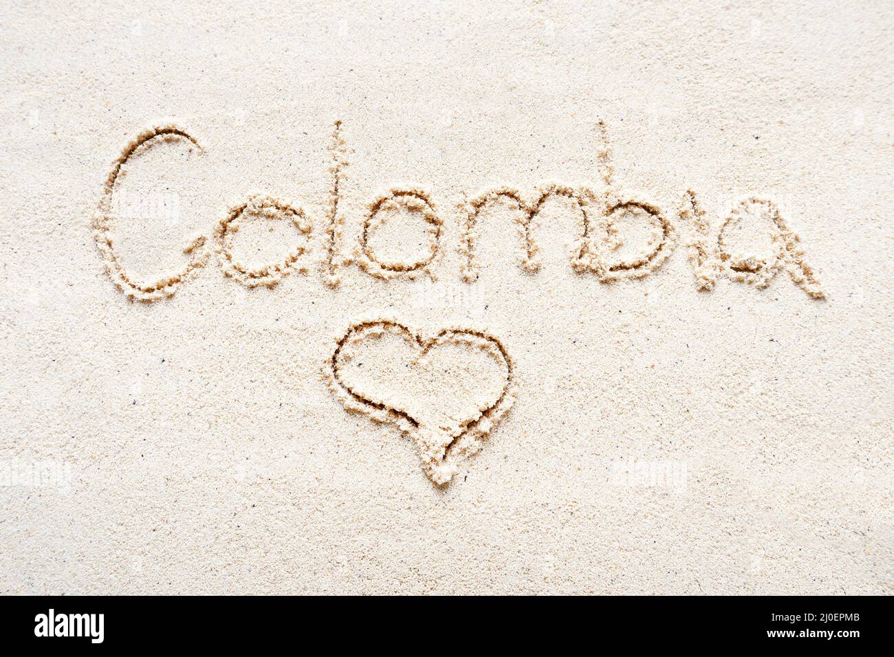 Handwriting words "Colombia" on sand of beach Stock Photo - Alamy