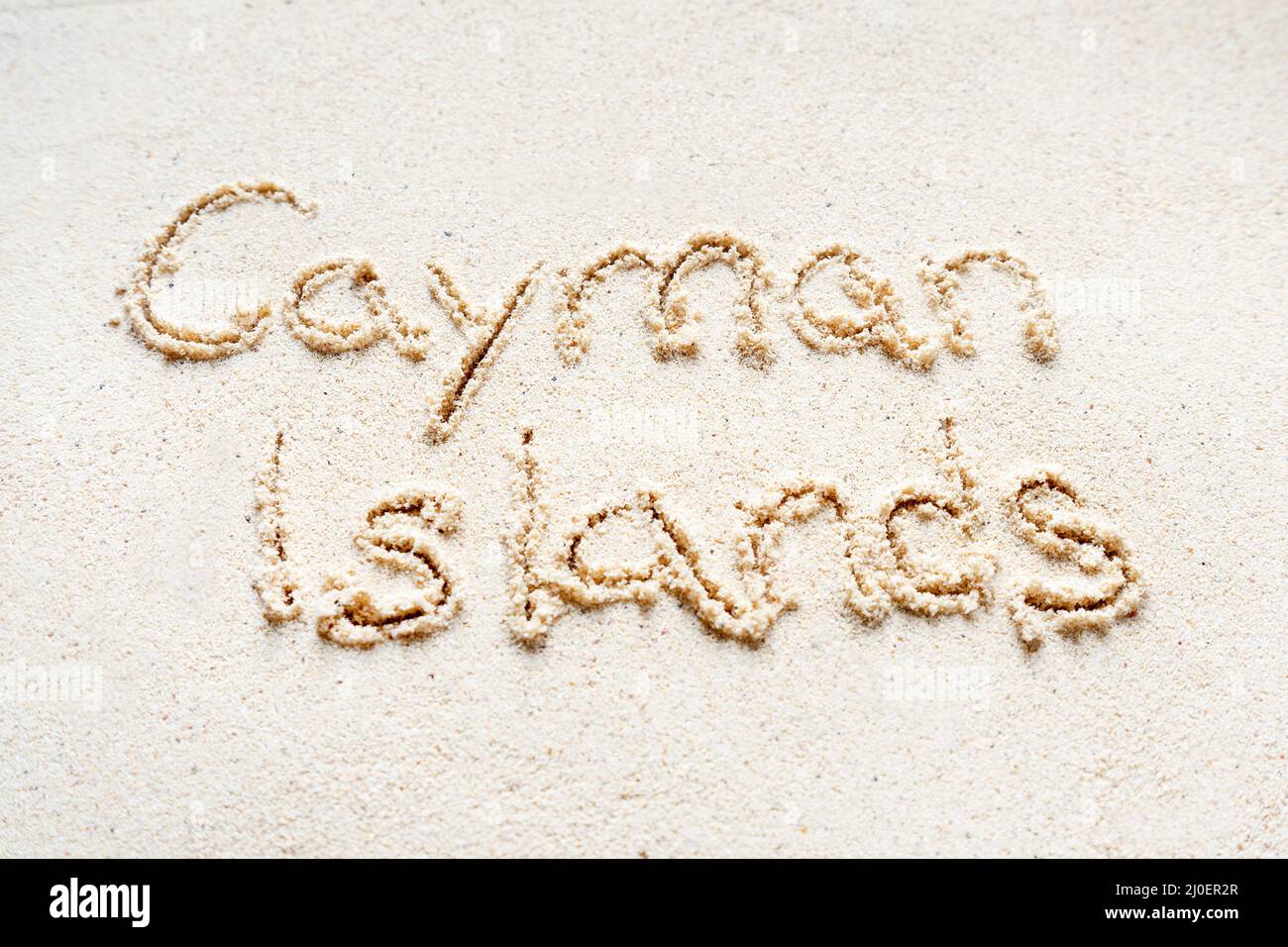 Handwriting words "Cayman islands" on sand of beach Stock Photo - Alamy