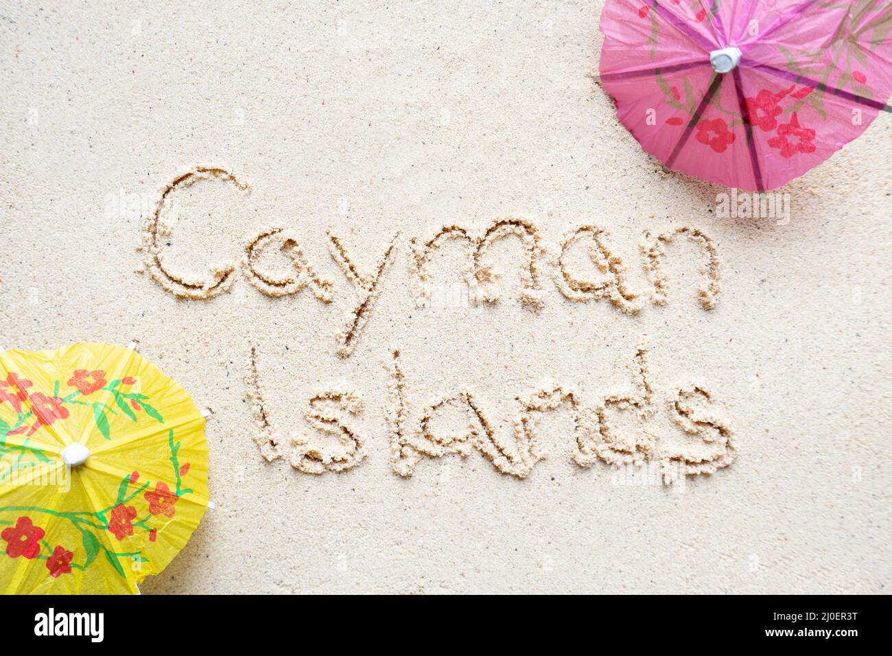 Handwriting words "Cayman islands" on sand of beach Stock Photo - Alamy