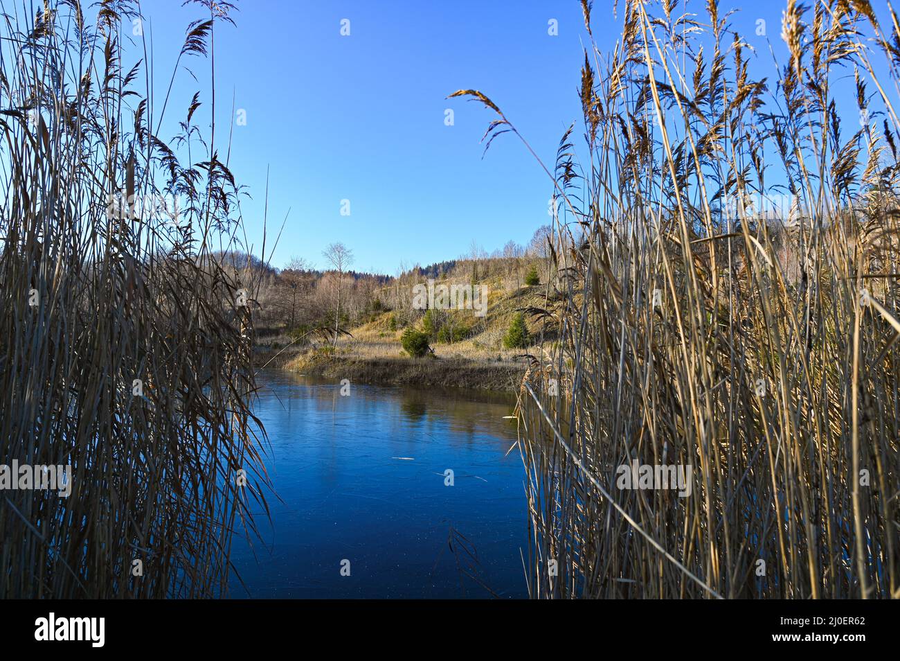 Lake between hills Stock Photo - Alamy
