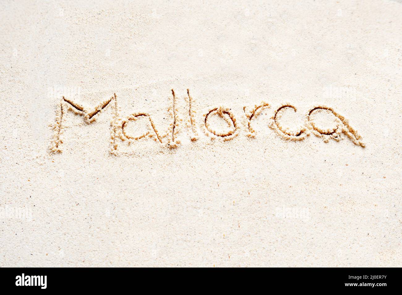 Handwriting words "Mallorca" on sand of beach Stock Photo - Alamy
