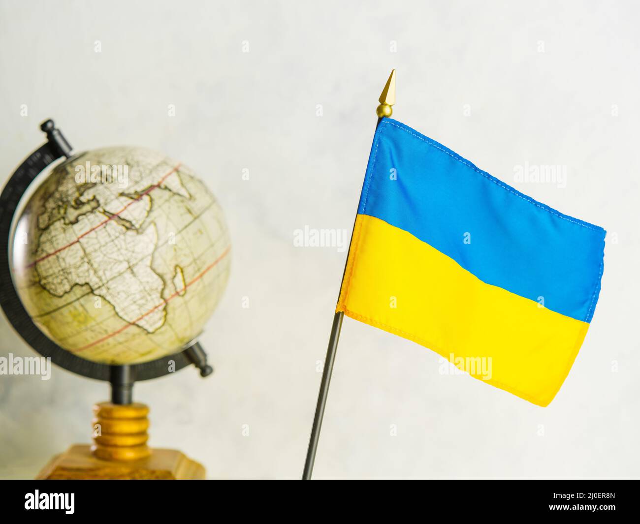 Ukraine flag and world globe on a white background. State in Eastern ...