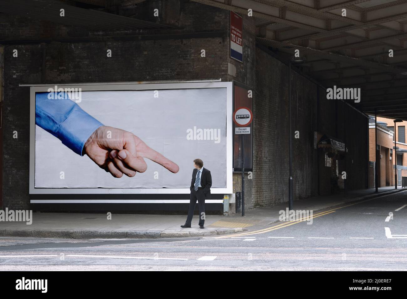 A businessman looking at a billboard Stock Photo - Alamy