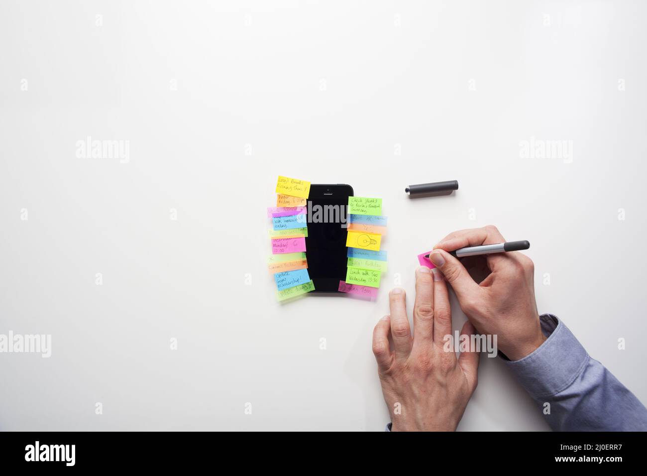 Top view of a man putting sticky notes on to a smart phone Stock Photo ...