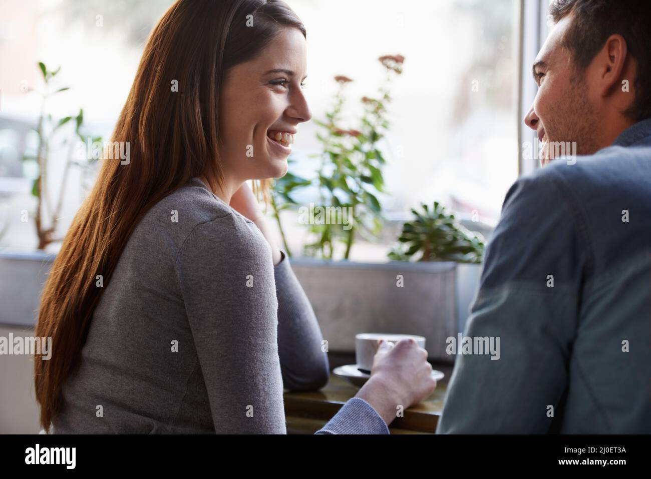 Getting to know each other. Shot of a young couple talking together in ...
