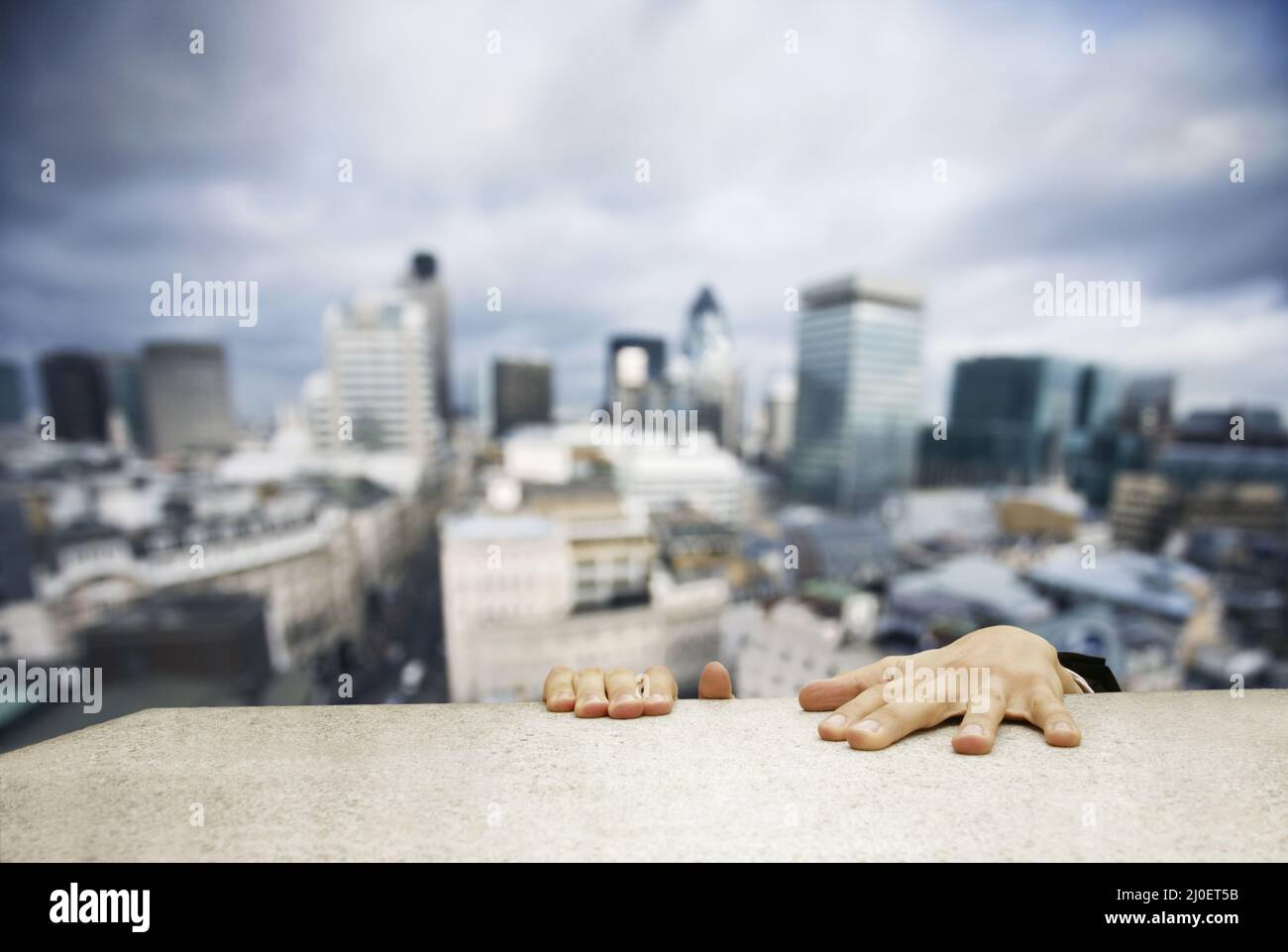 Holding on to the edge Stock Photo - Alamy