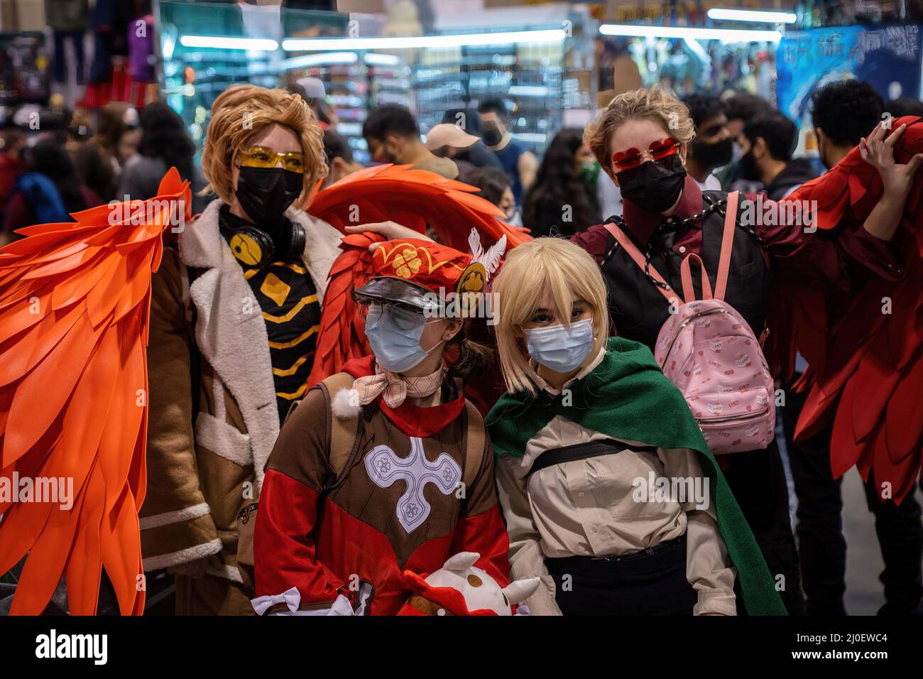 People dressed in costumes pose for a photo together during the event ...