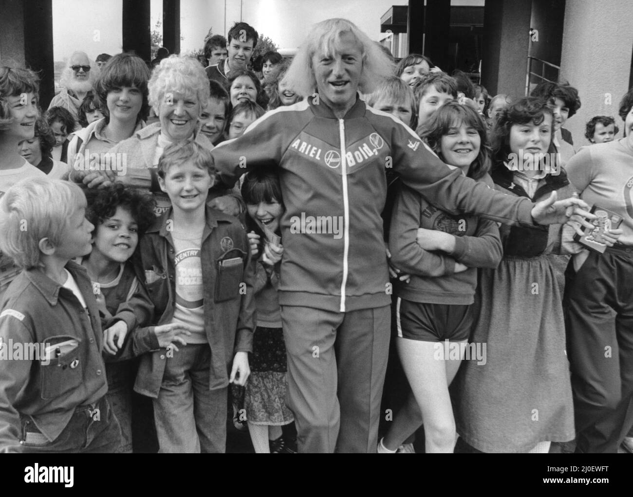 Disc Jockey and "Mr Fix-it" Jimmy Savile prepares with a group of ...